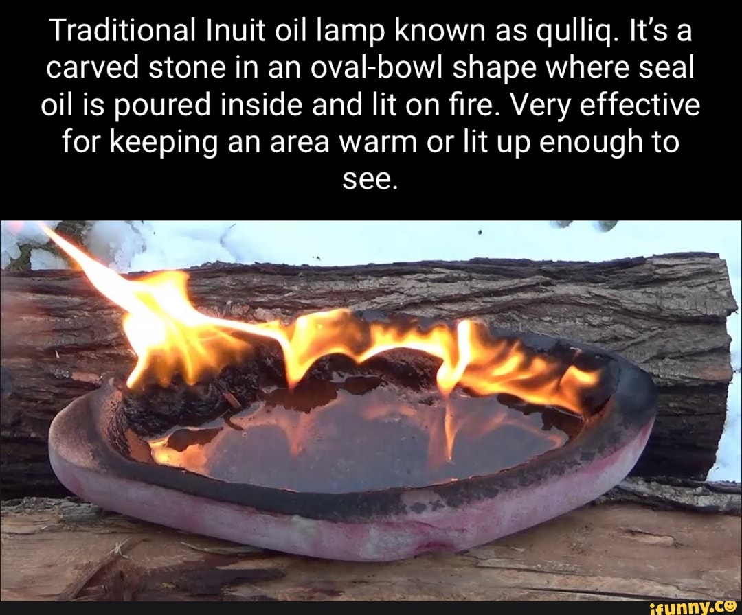 Traditional Inuit oil lamp known as qulliq. It's a carved stone in an ...