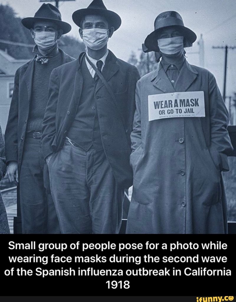 Small group of people pose for a photo while wearing face masks during ...