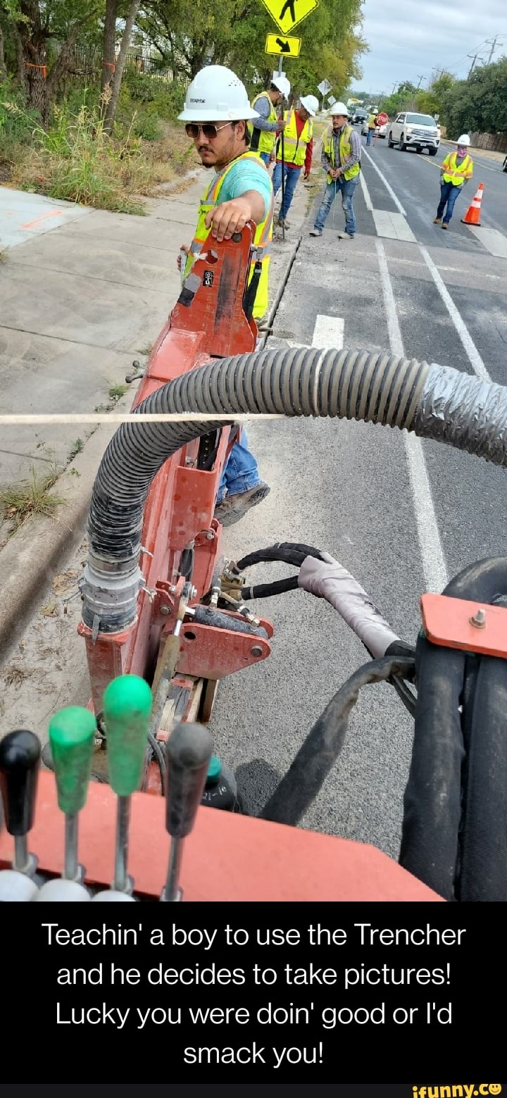 Teachin' a boy to use the Trencher and he decides to take pictures ...