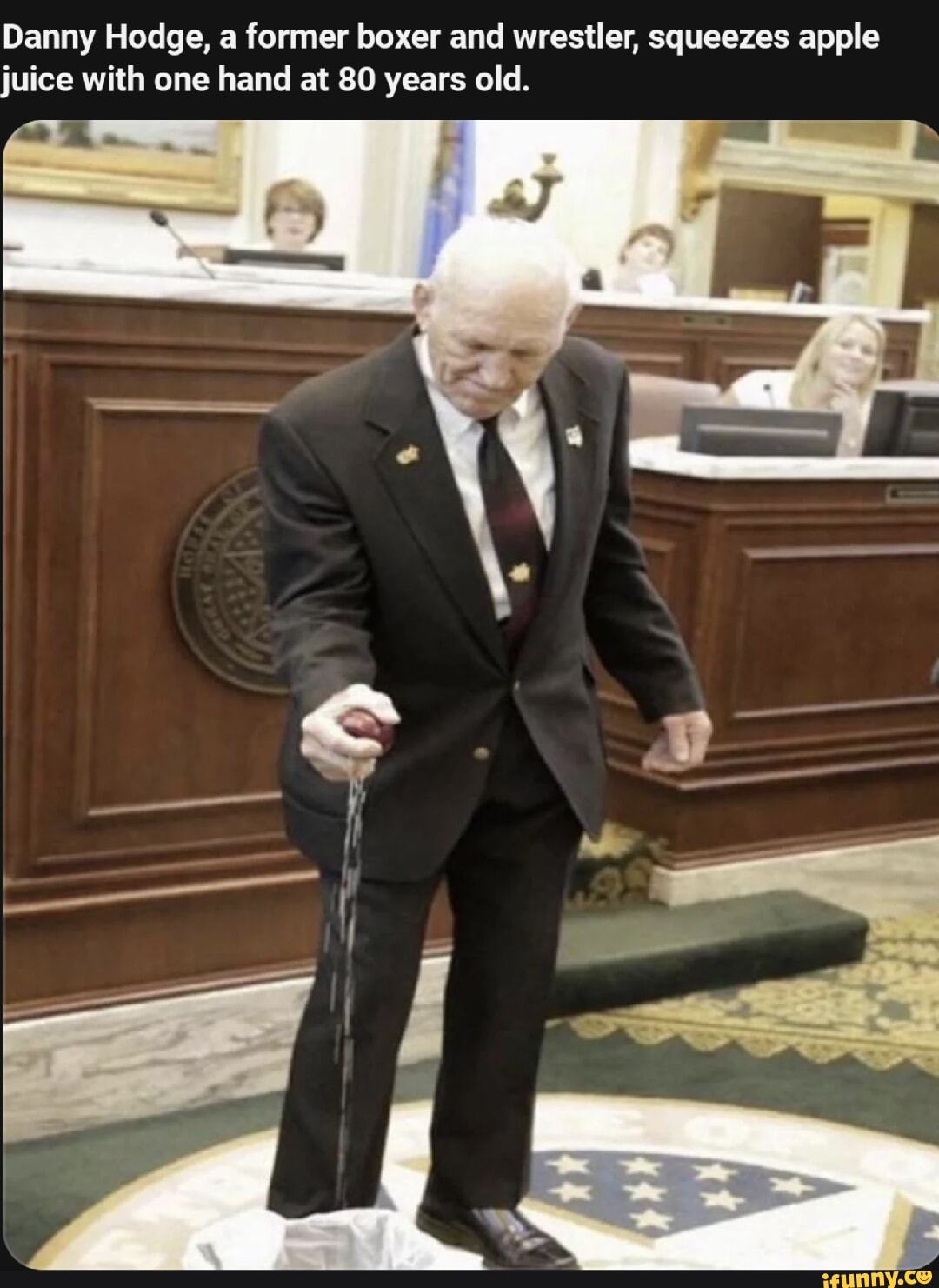 Danny Hodge, a former boxer and wrestler, squeezes apple juice with one ...