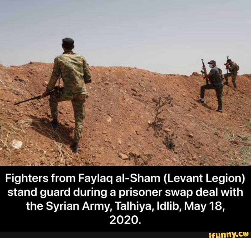 Fighters from Faylaq al-Sham (Levant Legion) stand guard during a ...